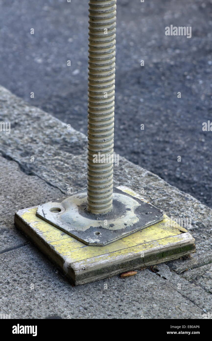 Close up on one scaffold foot upon a piece of wood in the street Stock ...