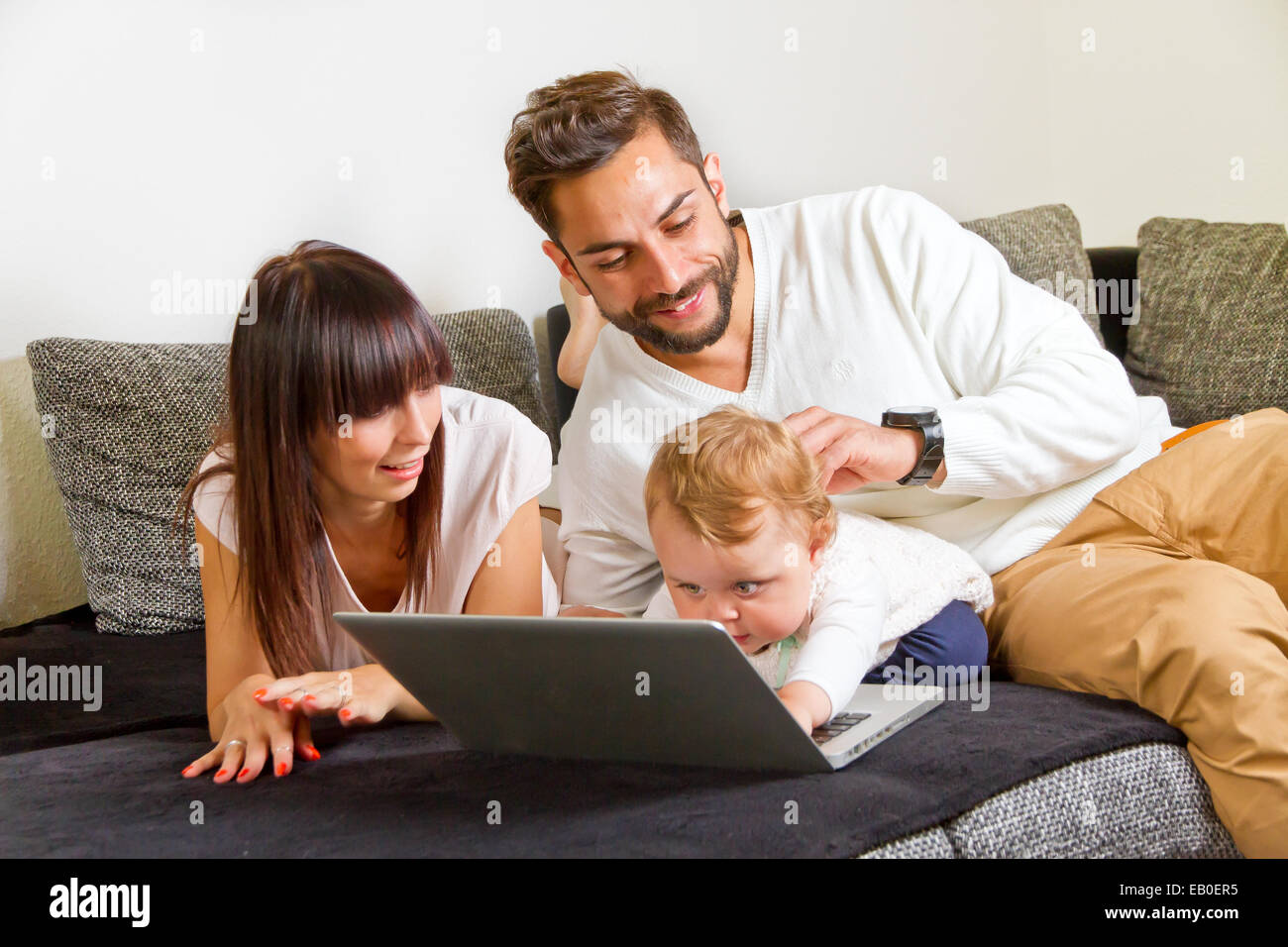 Young modern family on computer Stock Photo - Alamy