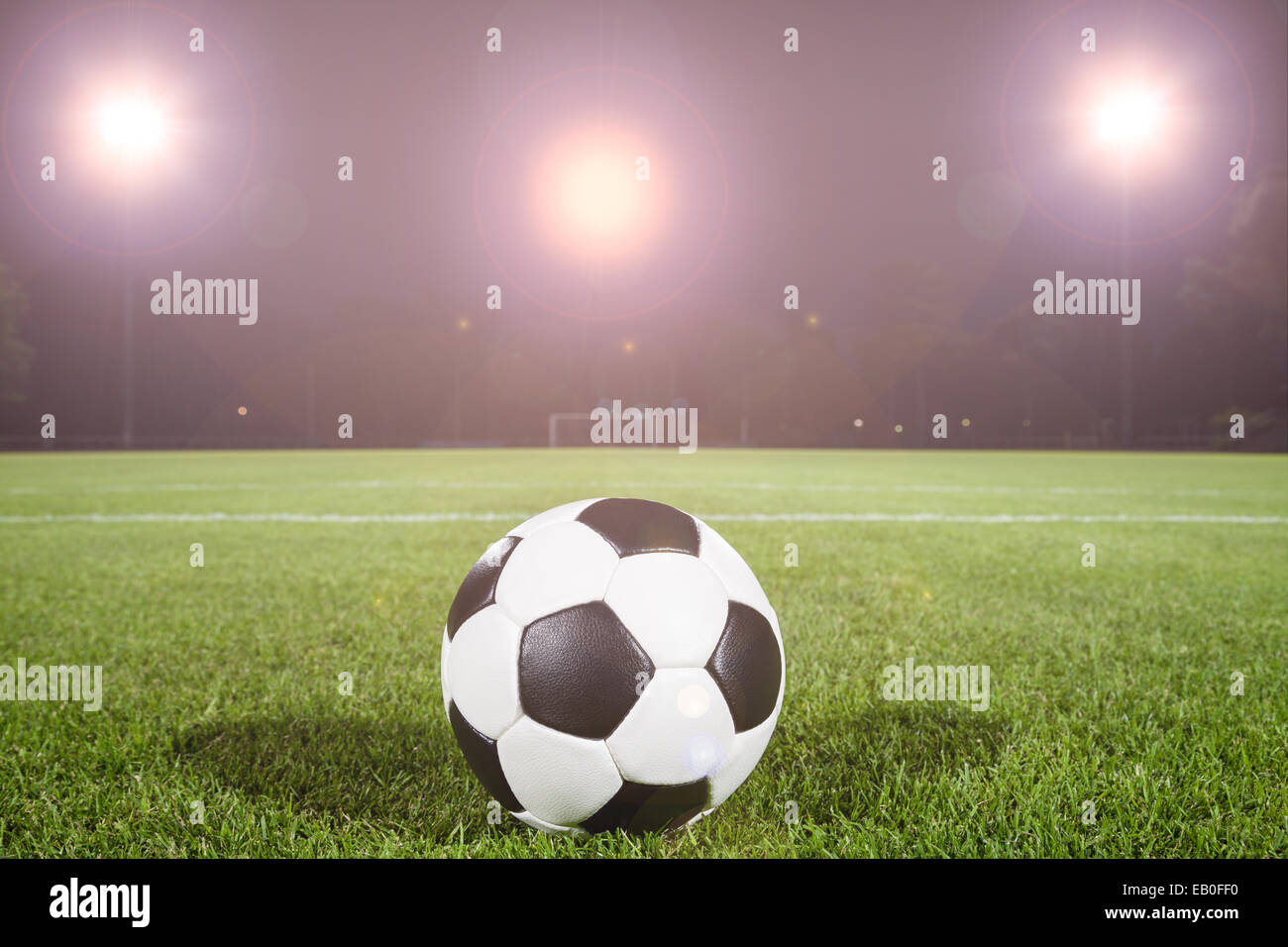soccer ball on field with light spots Stock Photo - Alamy