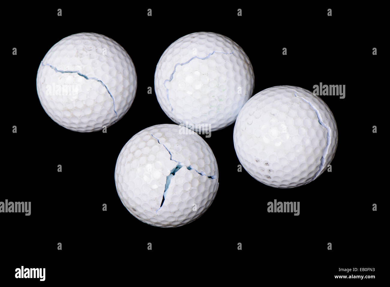 cracked golf balls, isolated on black background Stock Photo - Alamy