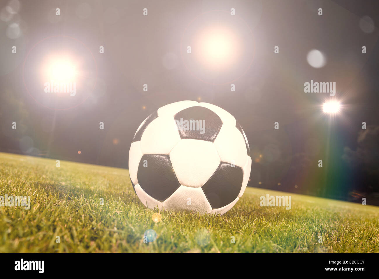 soccer ball on field with spots Stock Photo - Alamy
