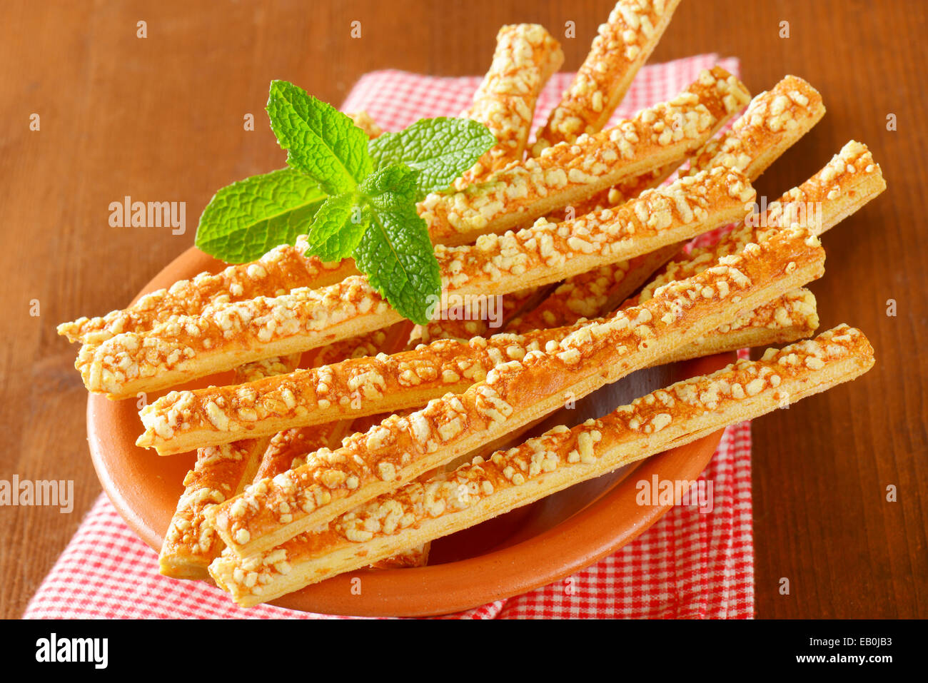 Puff-pastry strips with cheese topping Stock Photo - Alamy