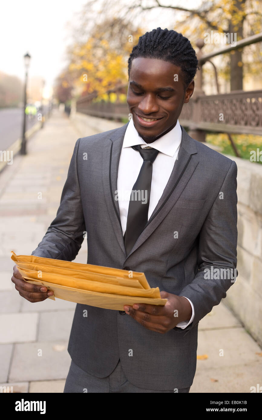 business man holding envelopes Stock Photo - Alamy