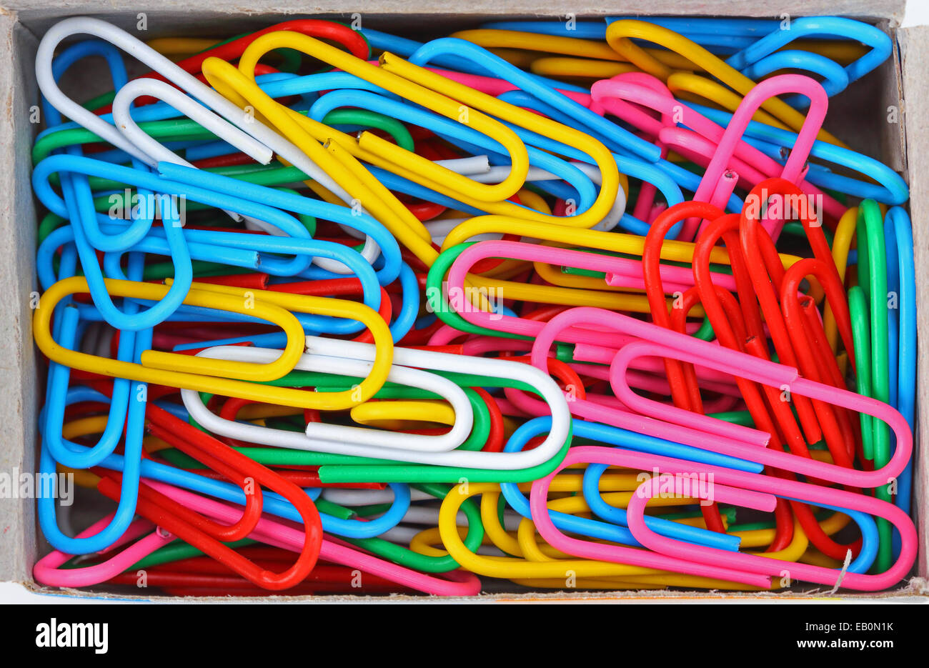 Colored paper clips on a white background closeup Stock Photo - Alamy