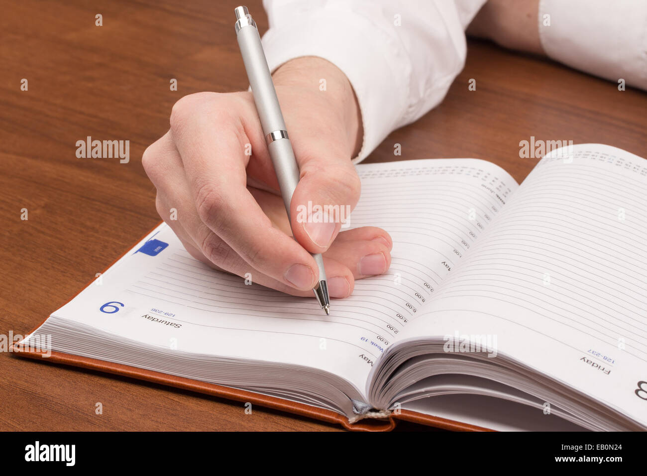Close up of hand writing and diary on a table Stock Photo - Alamy