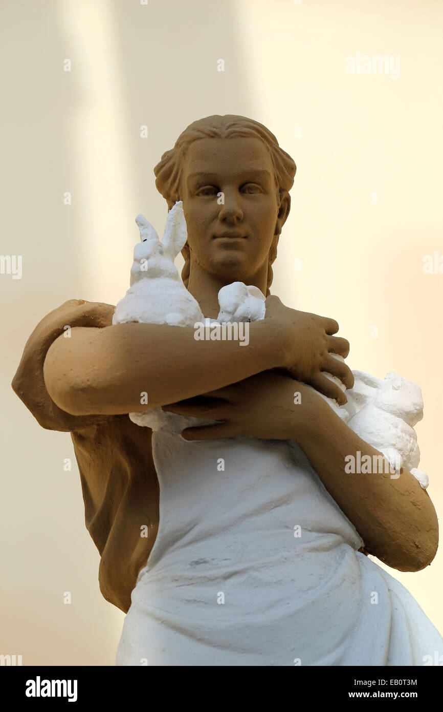 Statue of a girl with a rabbit in the exhibition pavilion building ...