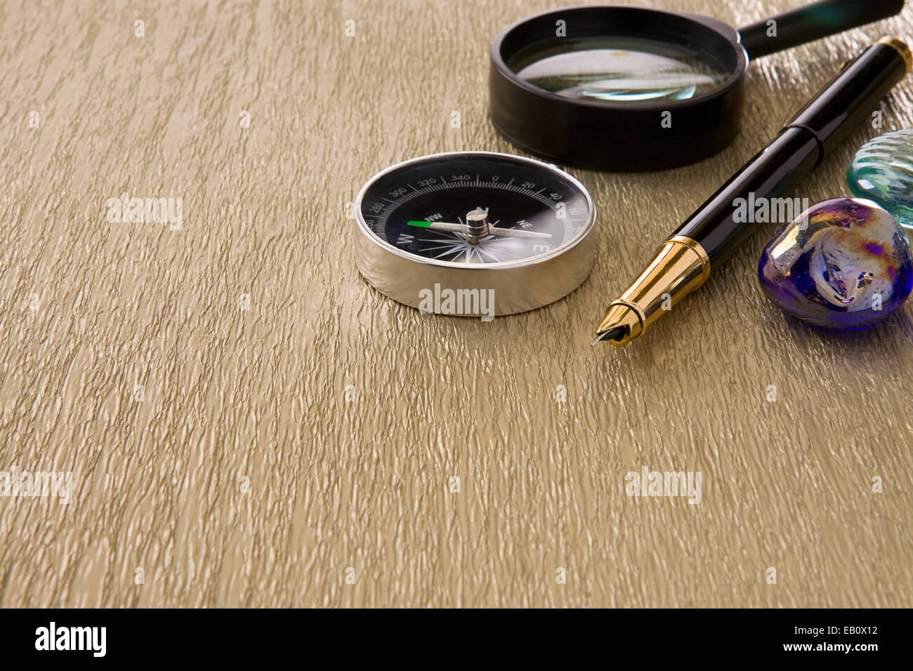 compass, ink pen and magnifier on gold old background texture Stock ...