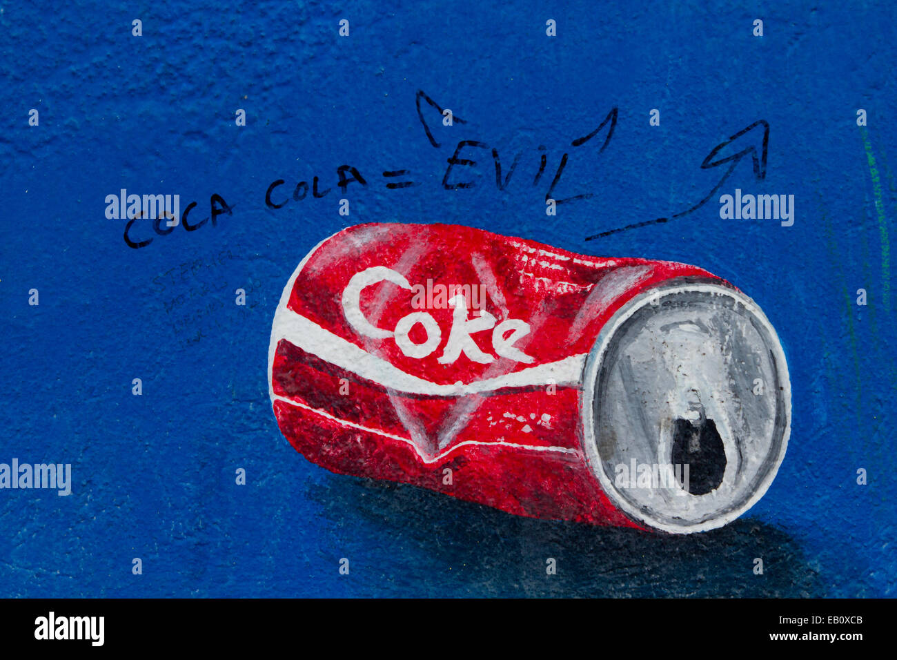 Berlin wall Street Art Graffiti coca cola evil Stock Photo - Alamy
