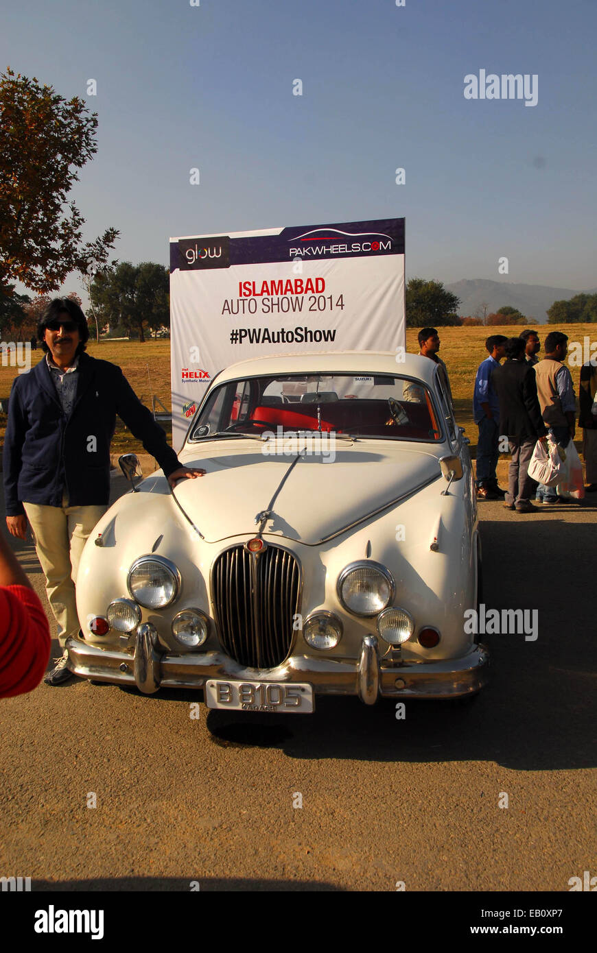 Islamabad. 23rd Nov, 2014. A visitor poses for a photo with a vintage ...