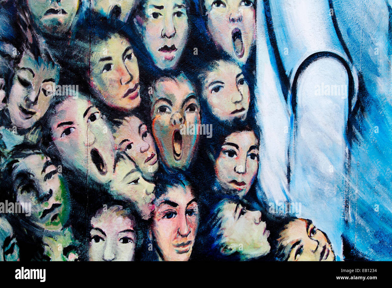 Graffiti tortured faces street art Berlin wall Stock Photo - Alamy