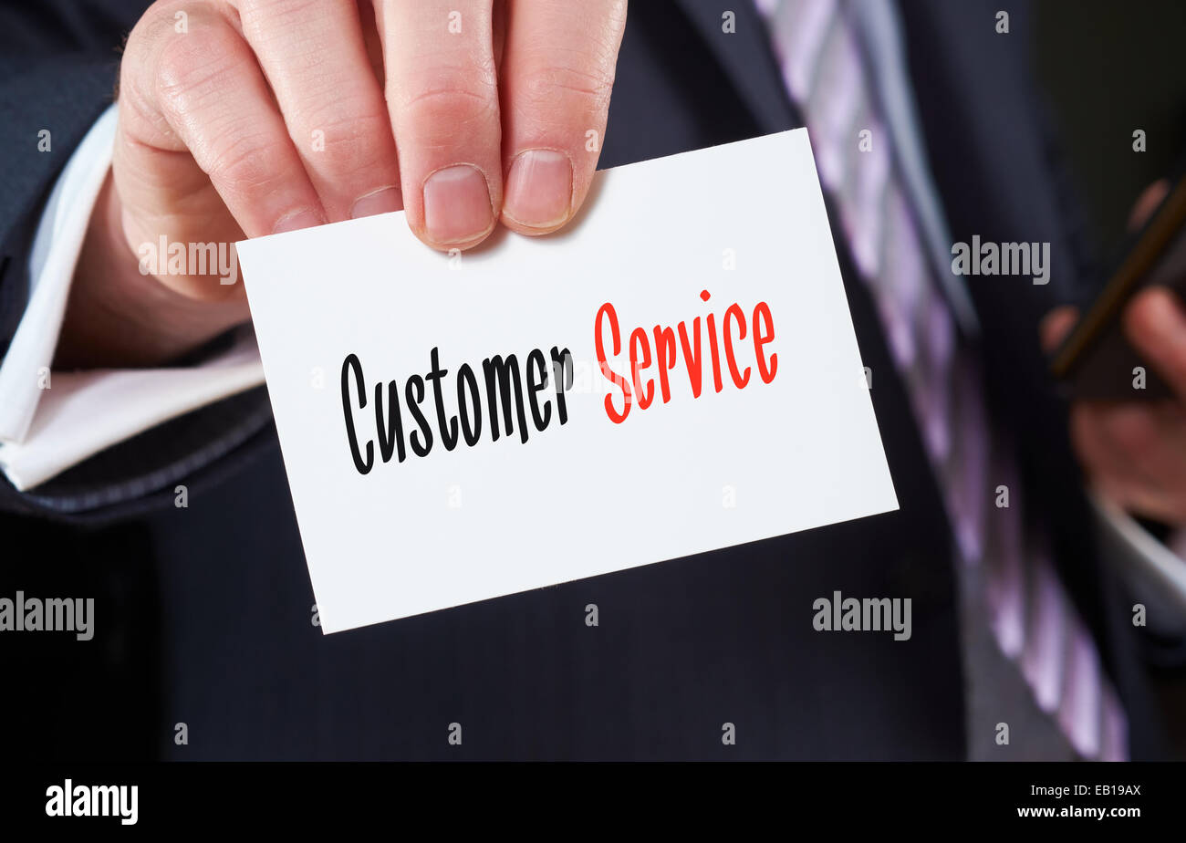 A businessman holding a business card with the words, Customer Service ...