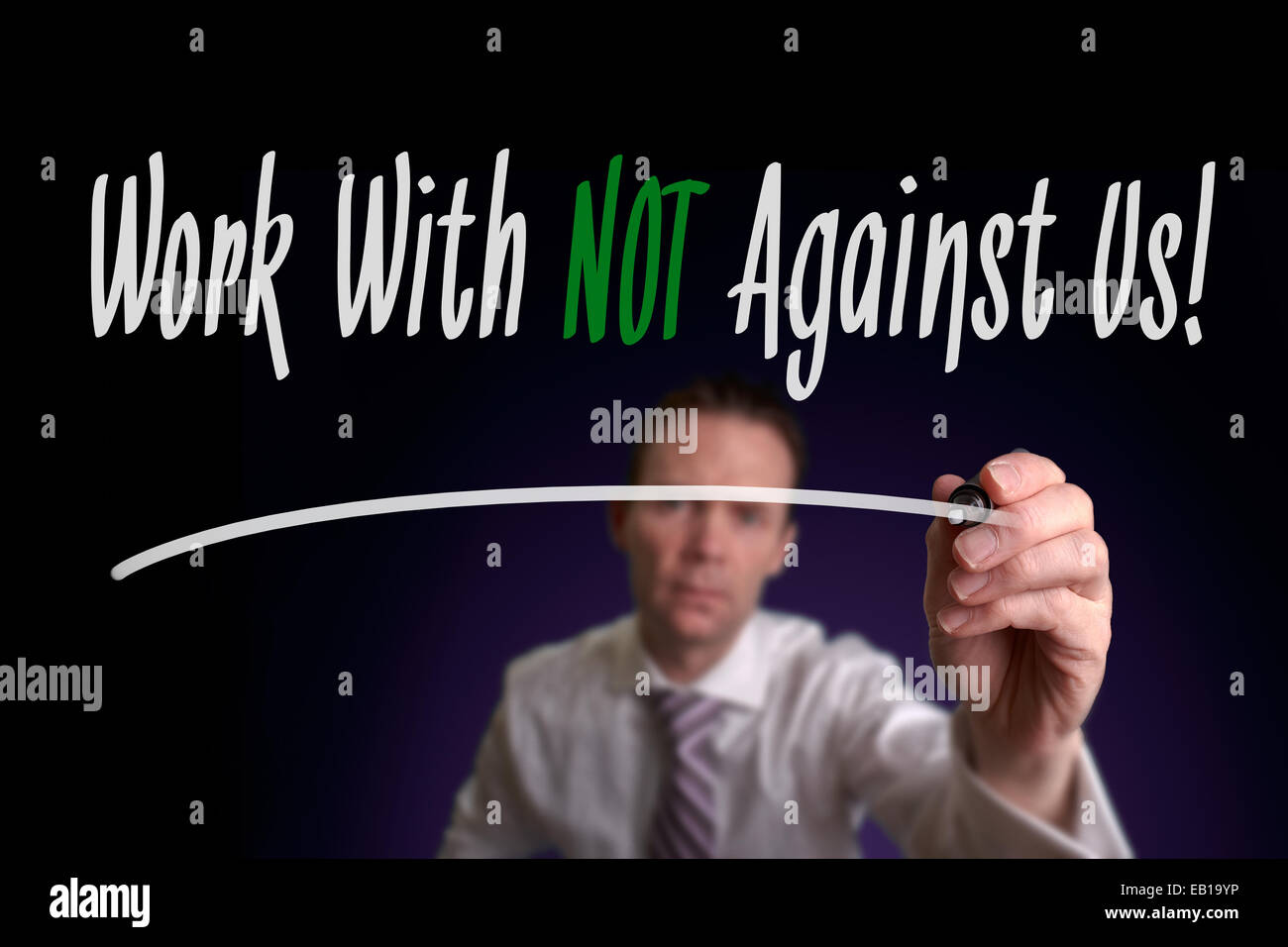 A businessman writing Work With Us Not Against Us on a screen. Business ...