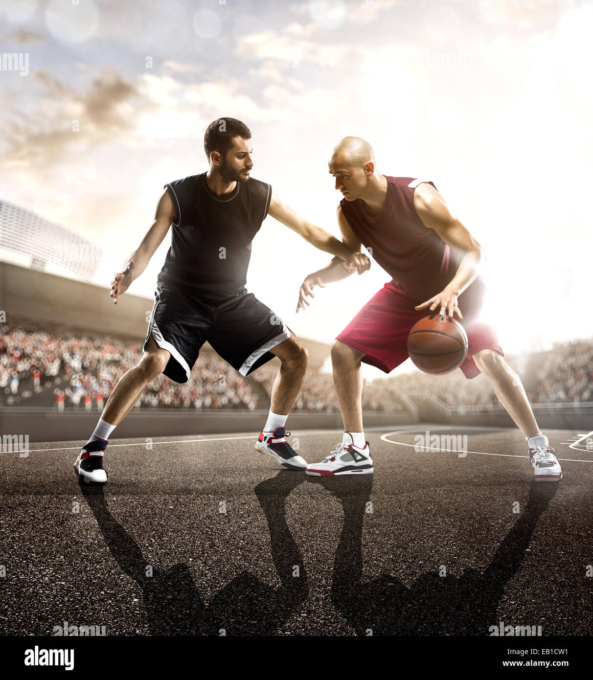 Basketball players in action on background of sky and crowd Stock Photo ...