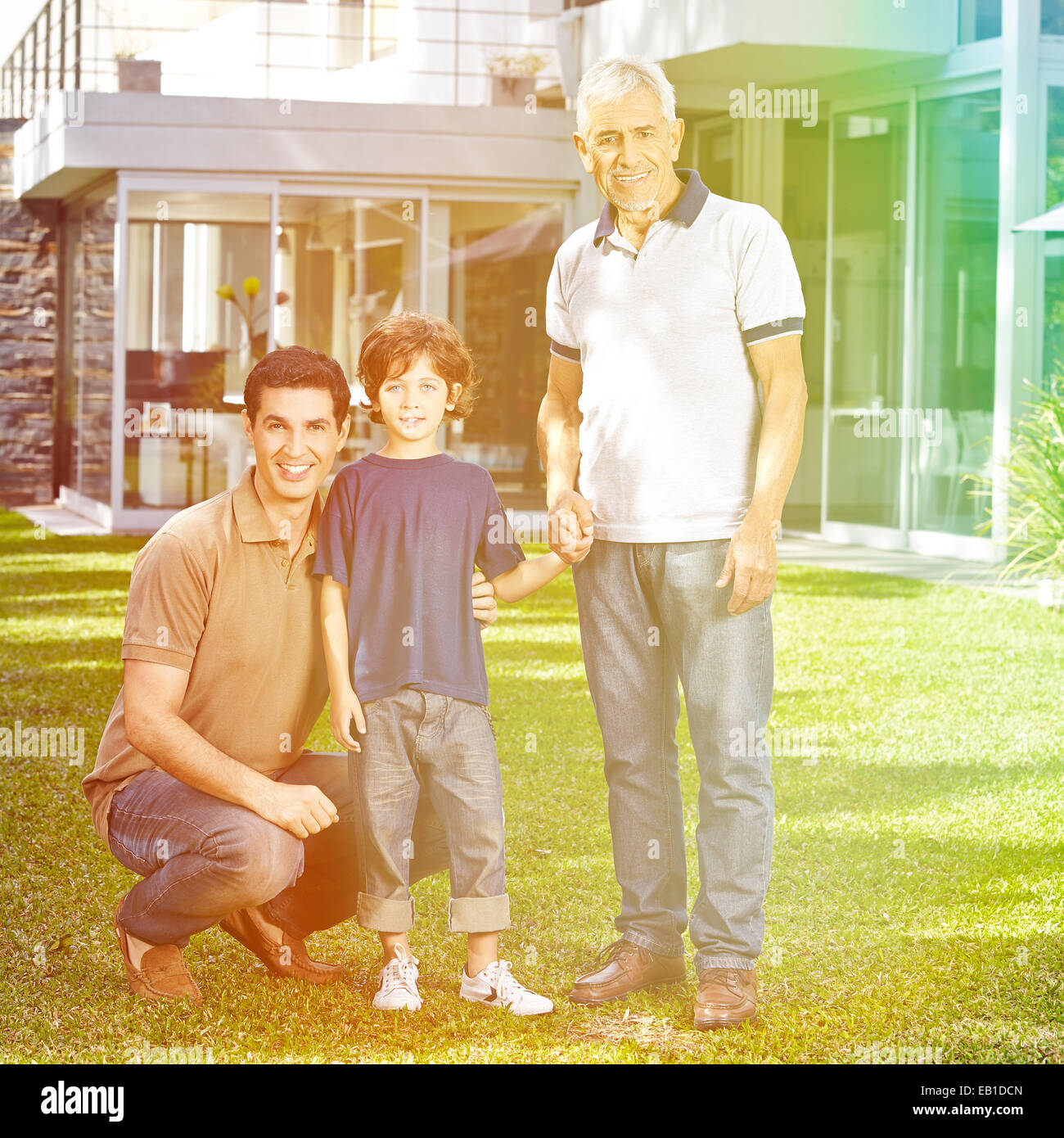 Smiling family in three generations in summer in a garden Stock Photo ...