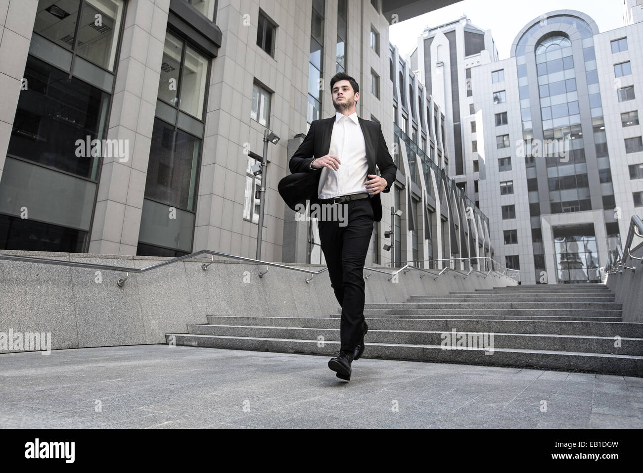 Business man is running away from office Stock Photo - Alamy