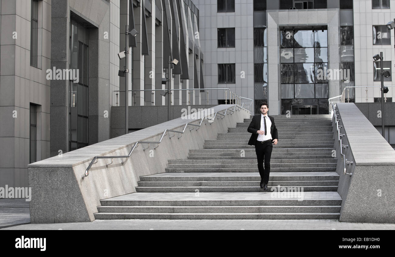 Business man is running away from office Stock Photo - Alamy