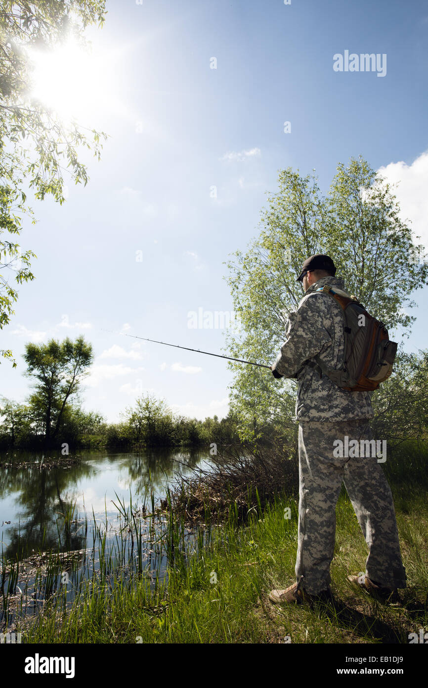 Angler in sunglasses is casting the top water lure Stock Photo - Alamy