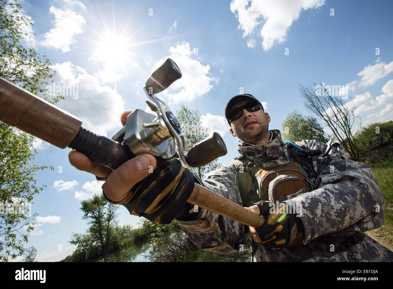 Angler in sunglasses is casting the top water lure Stock Photo - Alamy