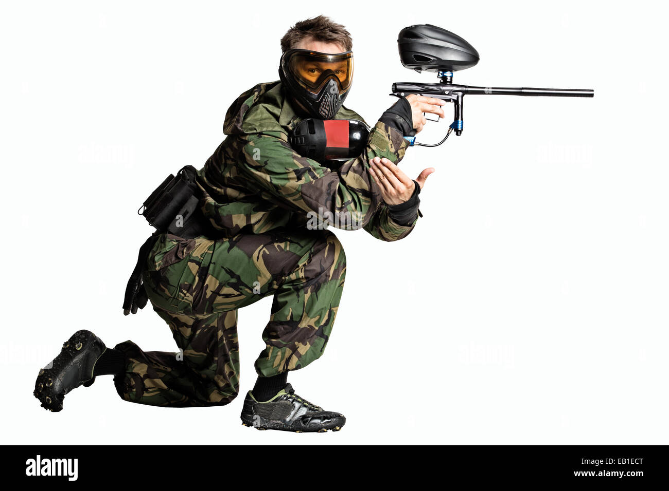 Isolated on white painball player in action Stock Photo - Alamy