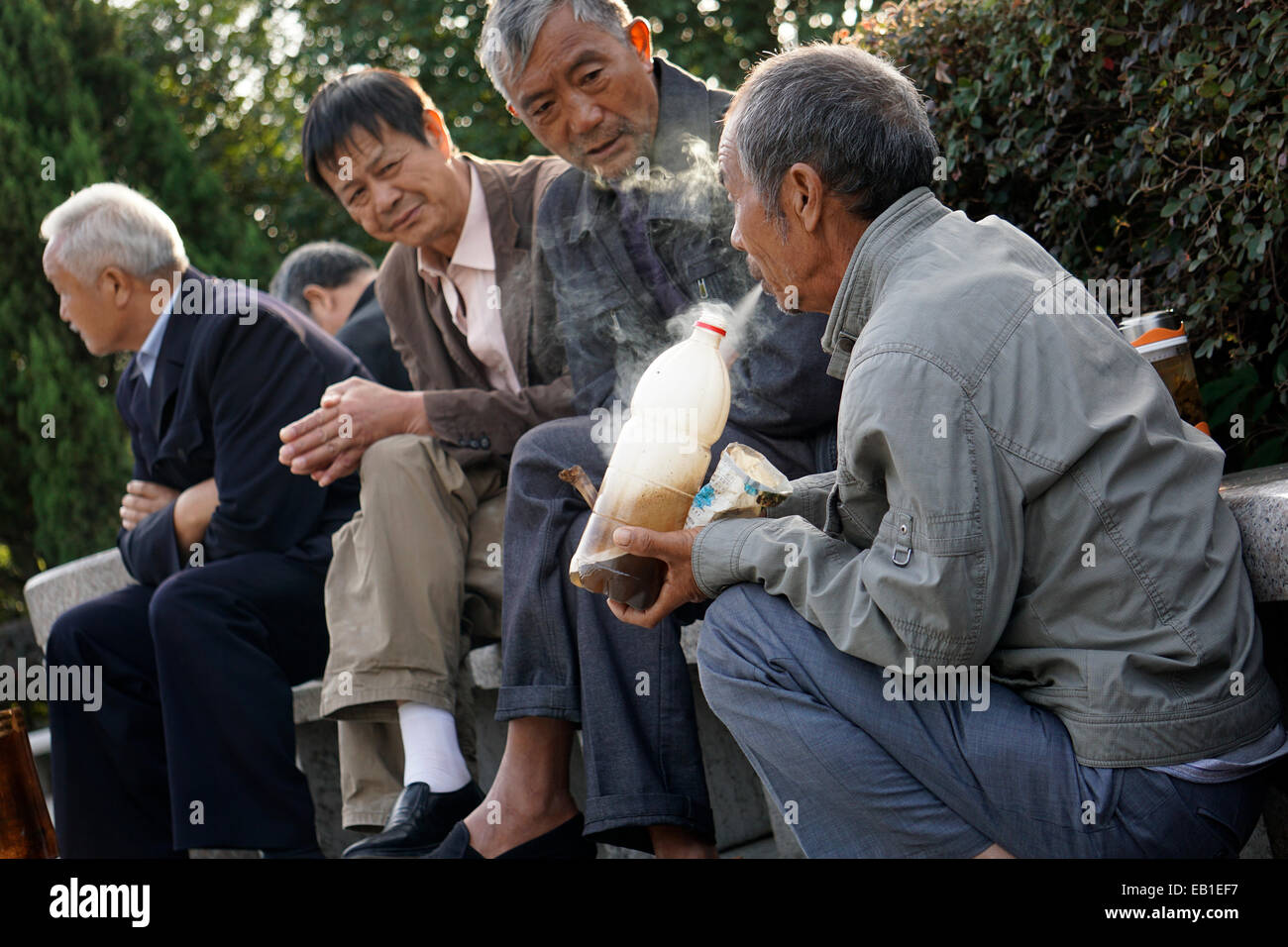 Seniors having social smoke in the park Stock Photo - Alamy