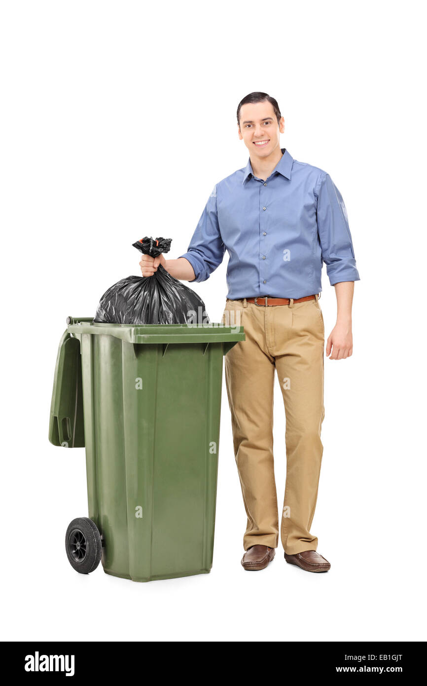 Full length portrait of a young man throwing out the garbage isolated ...