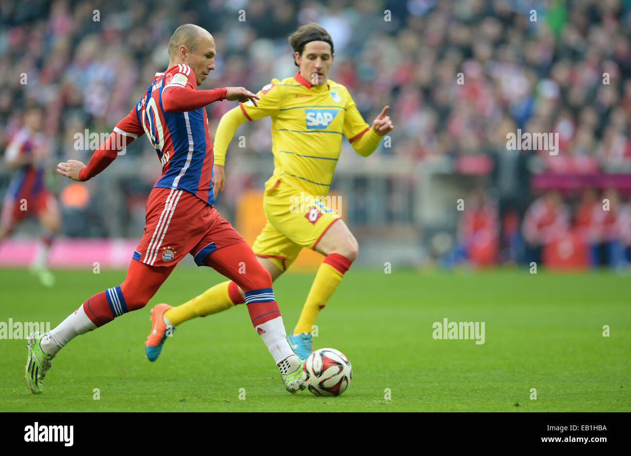 Munich, Germany. 22nd Nov, 2014. Munich's Arjen Robben (L) vies for the ...