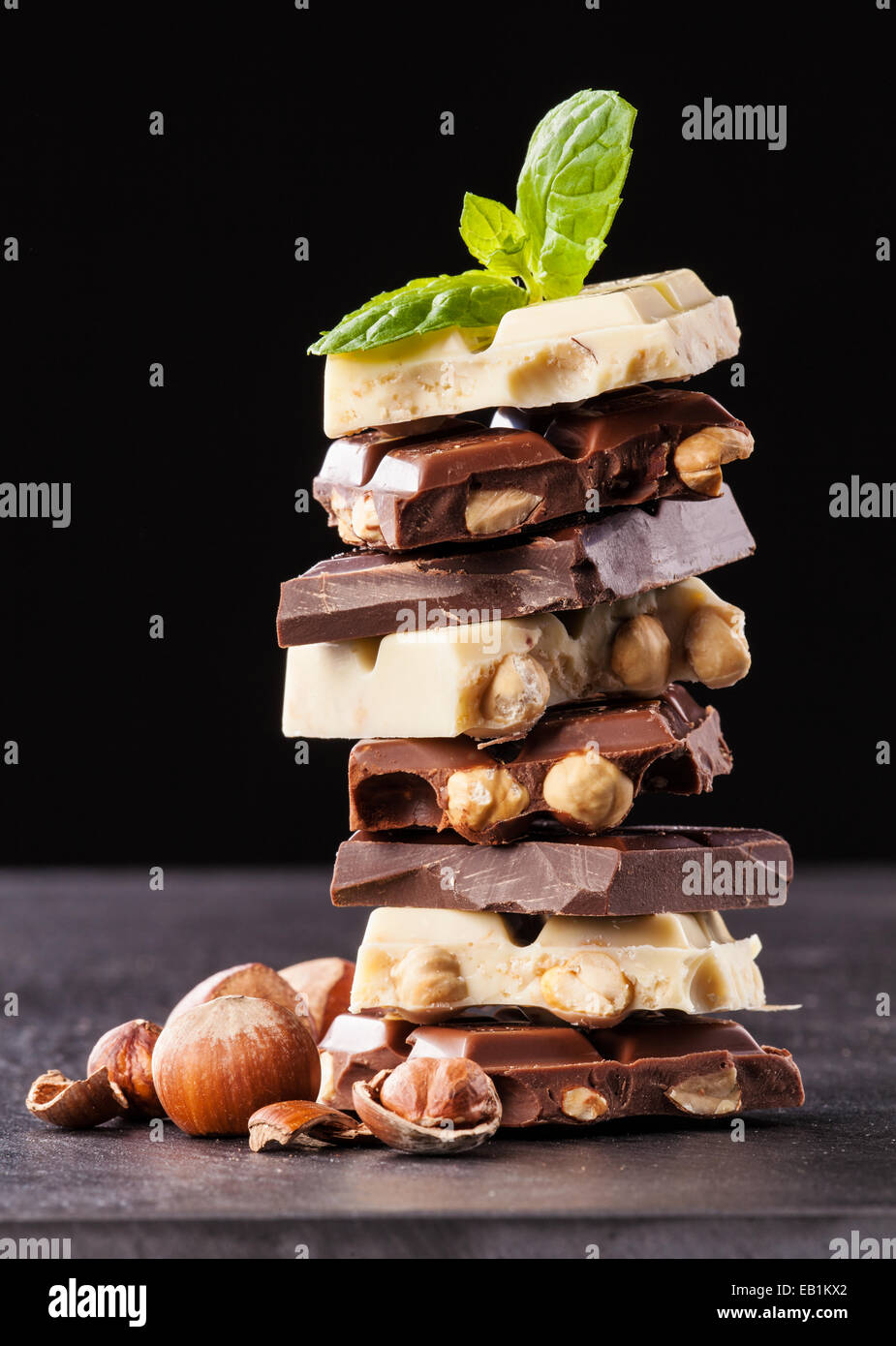 Pile of hazelnut chocolate isolated on black background Stock Photo - Alamy
