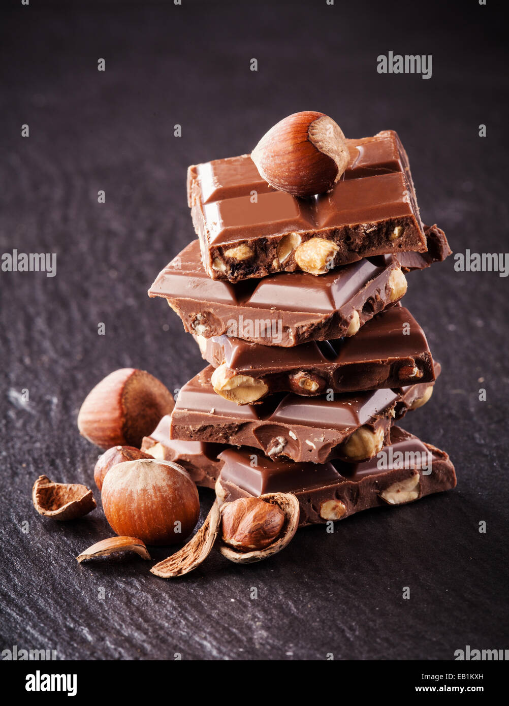 Pile of hazelnut chocolate isolated on black background Stock Photo - Alamy