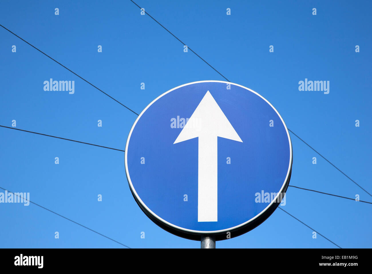 One Way Sign with Trolley Bus Lines against Blue Sky Stock Photo - Alamy