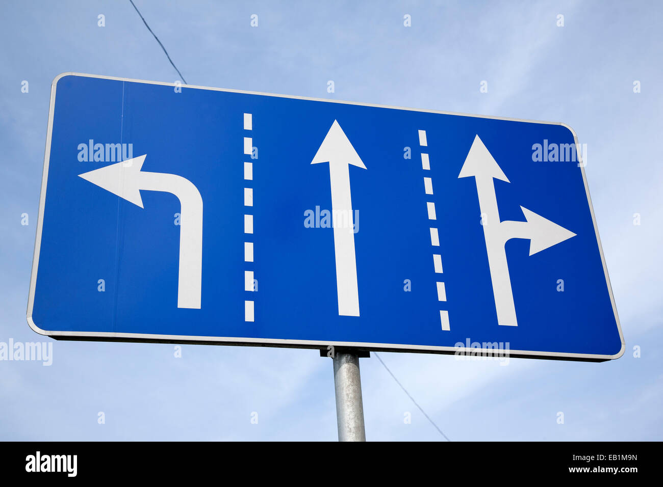 Three Way Direction Sign against Blue Sky Background Stock Photo - Alamy