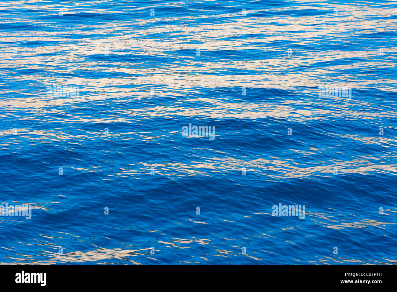 Colors from an island and early morning sunrise cause rich, blue and ...