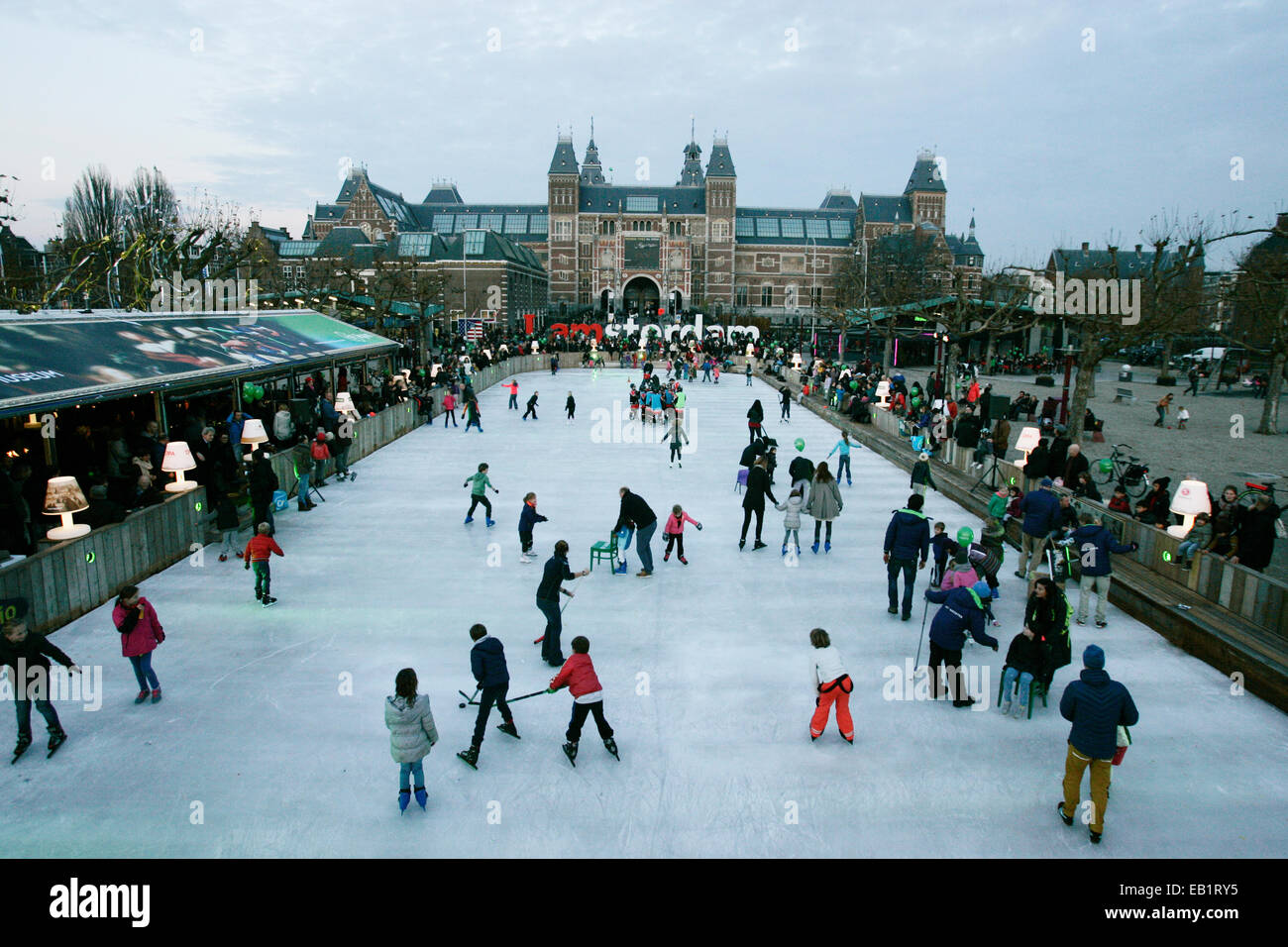 People enjoy on the traditional ice skating rink outside the ...