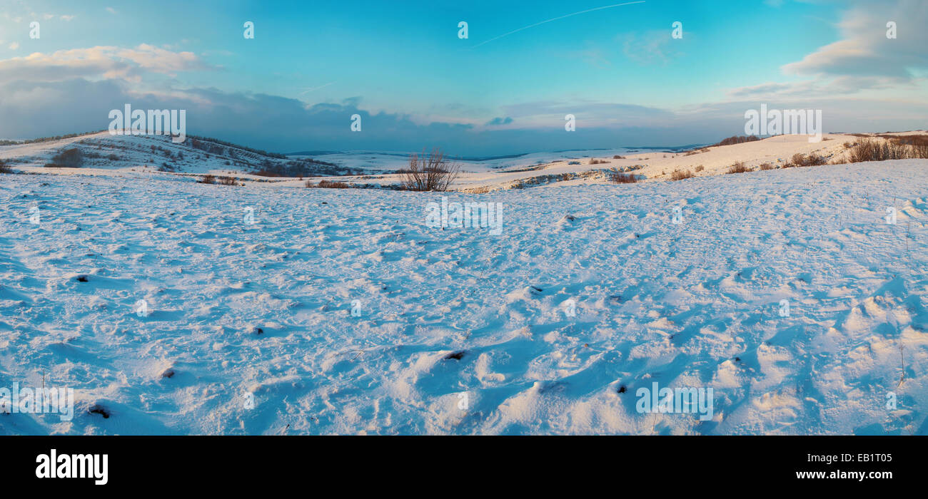 Panorama with winter hills covered by snow against sunset Stock Photo ...