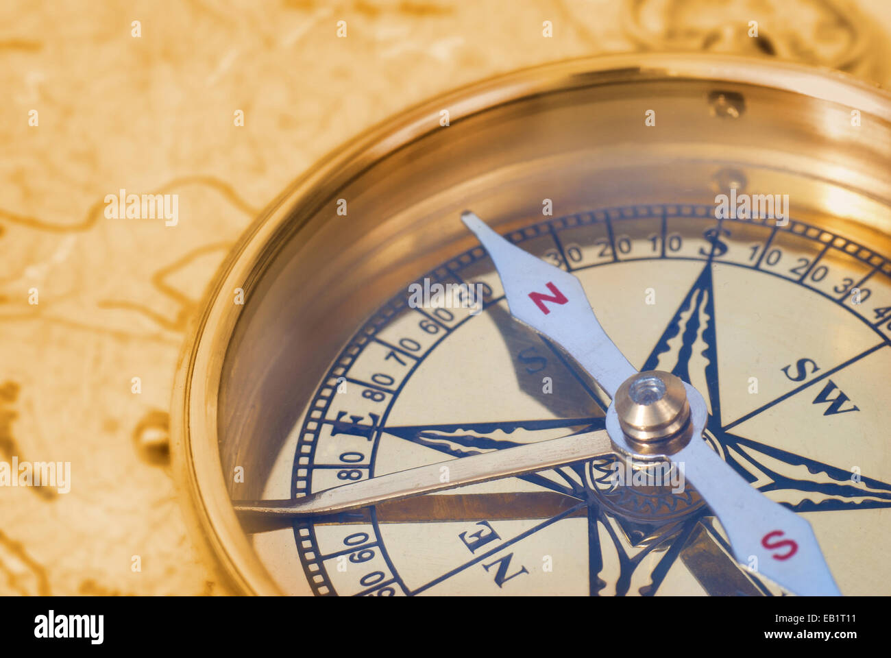 Ancient compass on the grunge old map Stock Photo - Alamy
