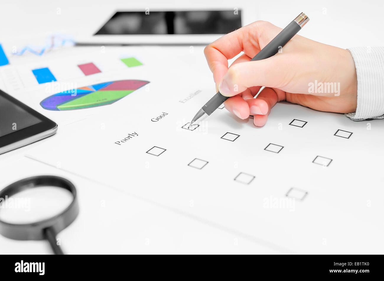 Examination paper on the office desk. Hand marks the estimate Stock ...