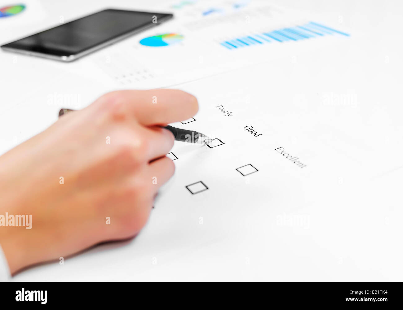 Examination paper on the office desk. Hand marks the estimate Stock ...