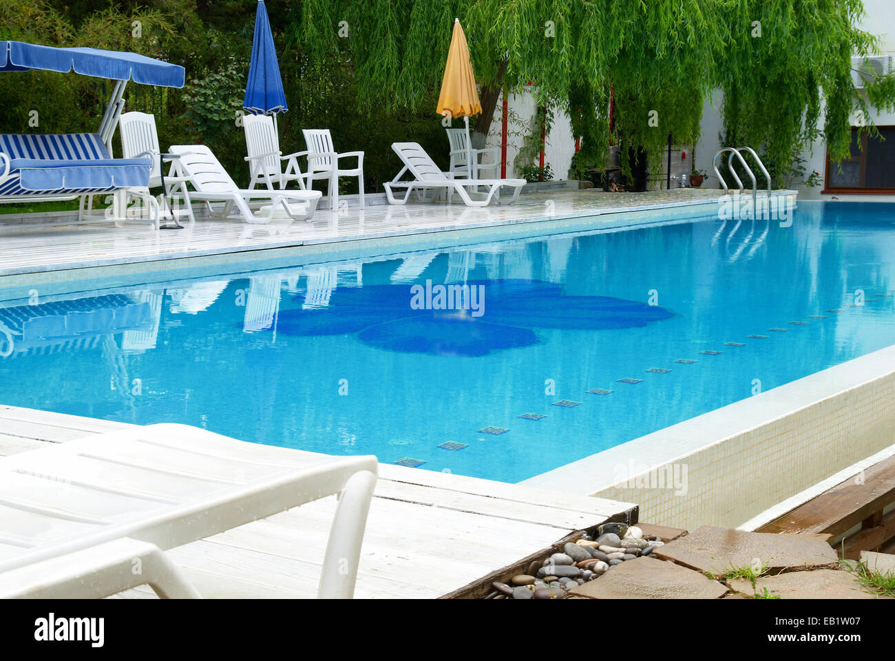 Swimming pool in the hotel with blue relaxing water Stock Photo - Alamy