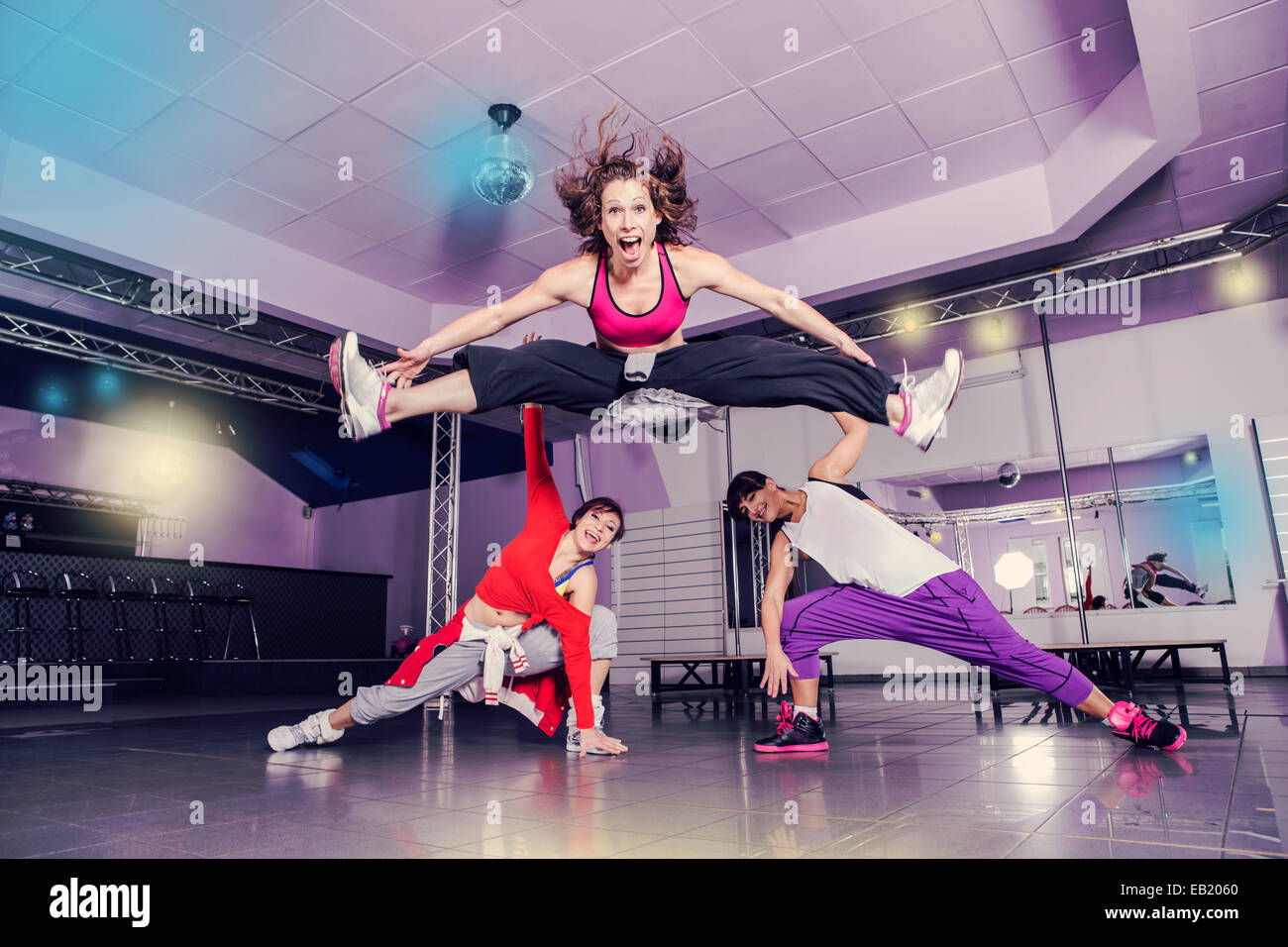 group of women in sport dress jumping at fitness dance excercise or ...