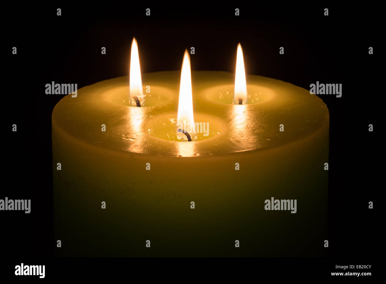 Candle with three flames isolated on black background Stock Photo - Alamy