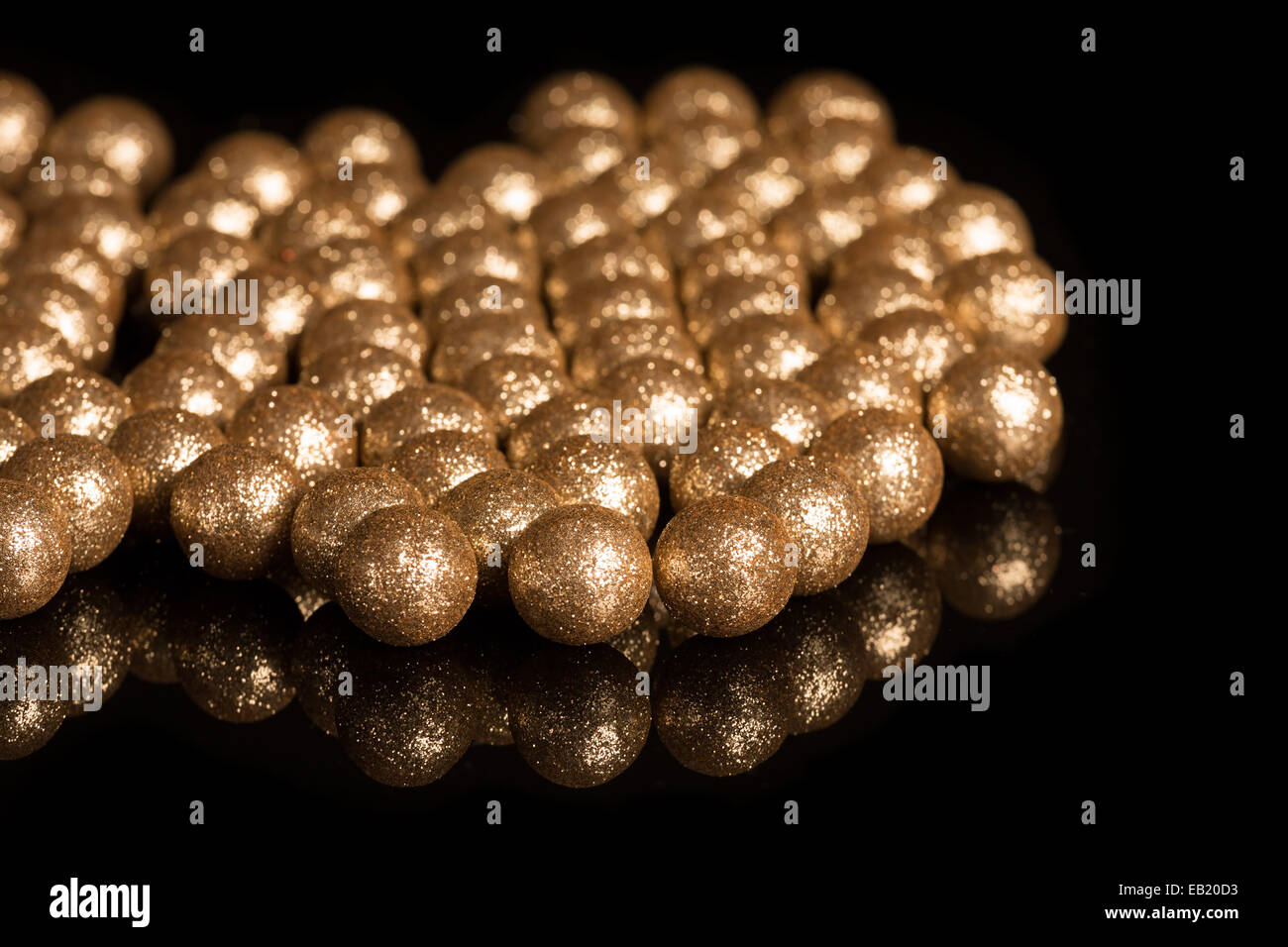 Several gilded balls on a black background Stock Photo - Alamy
