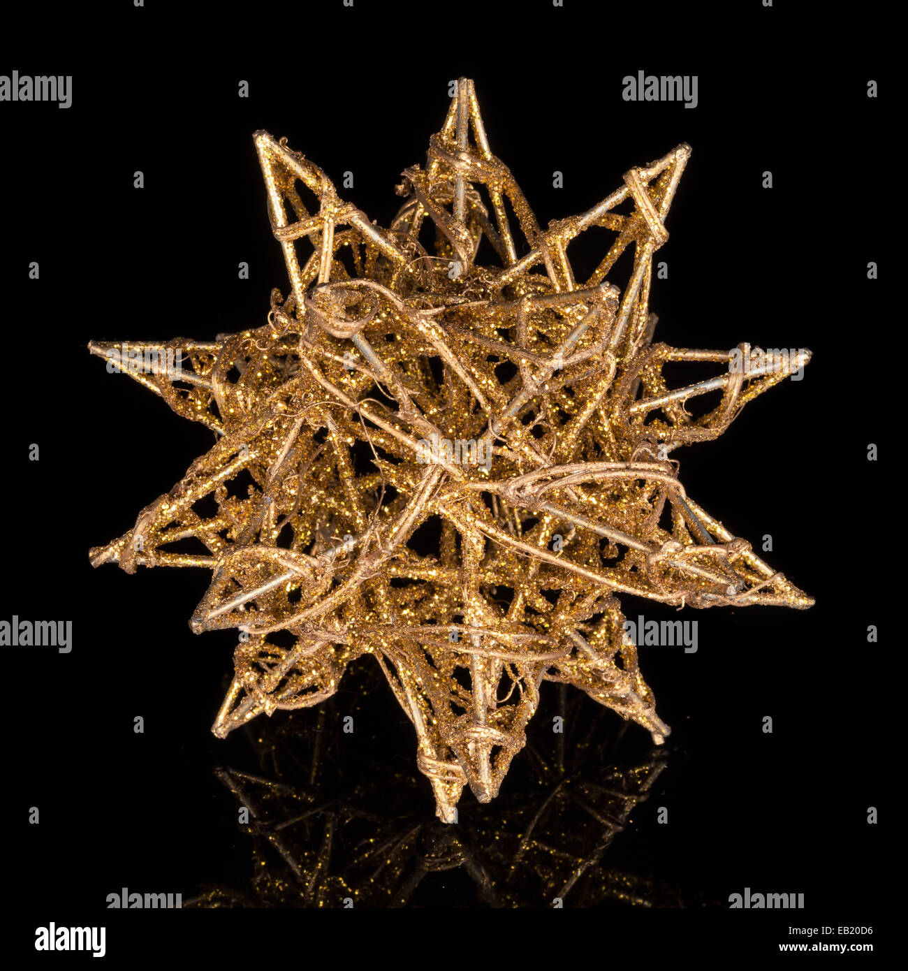 Gilded star isolated on a black background Stock Photo - Alamy