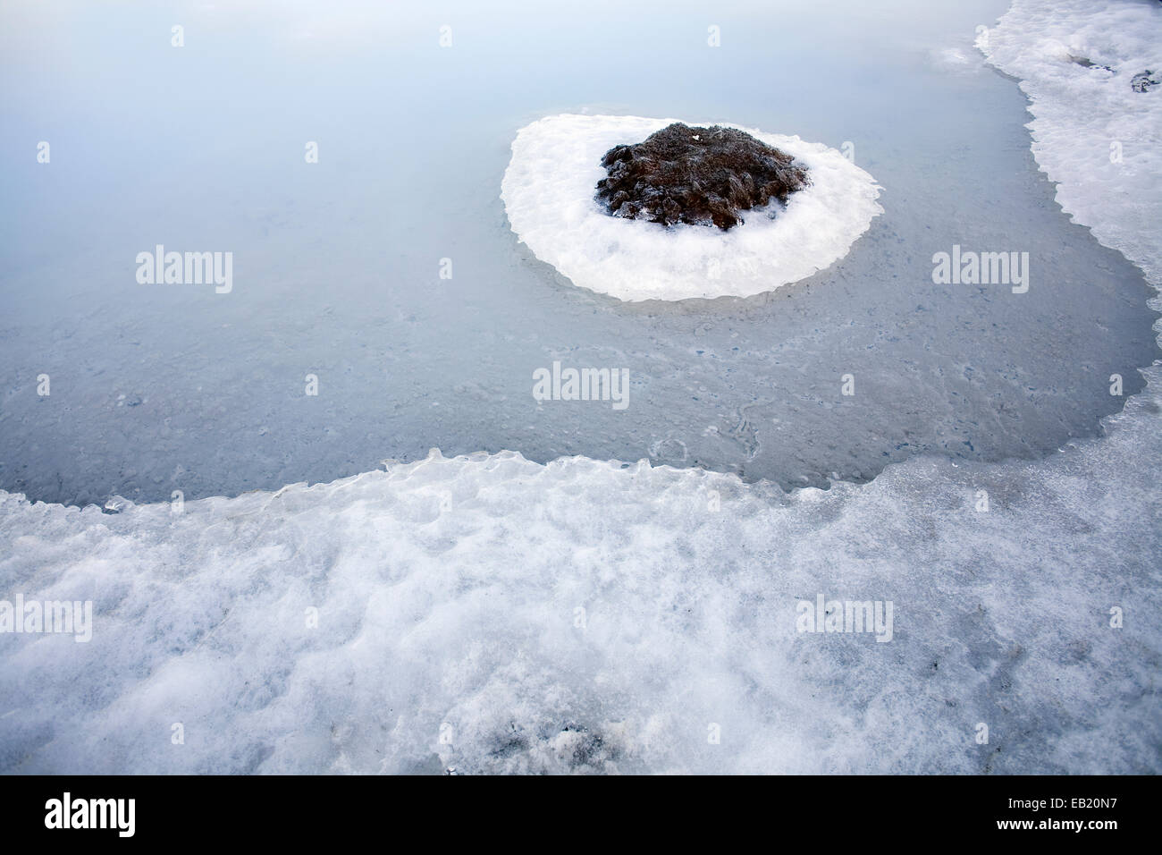 Ice melting around rock in Iceland Stock Photo - Alamy