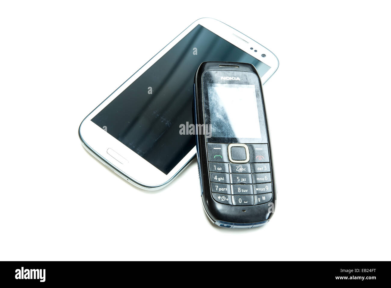 A modern smartphone and a old classic cell phone side by side Stock ...