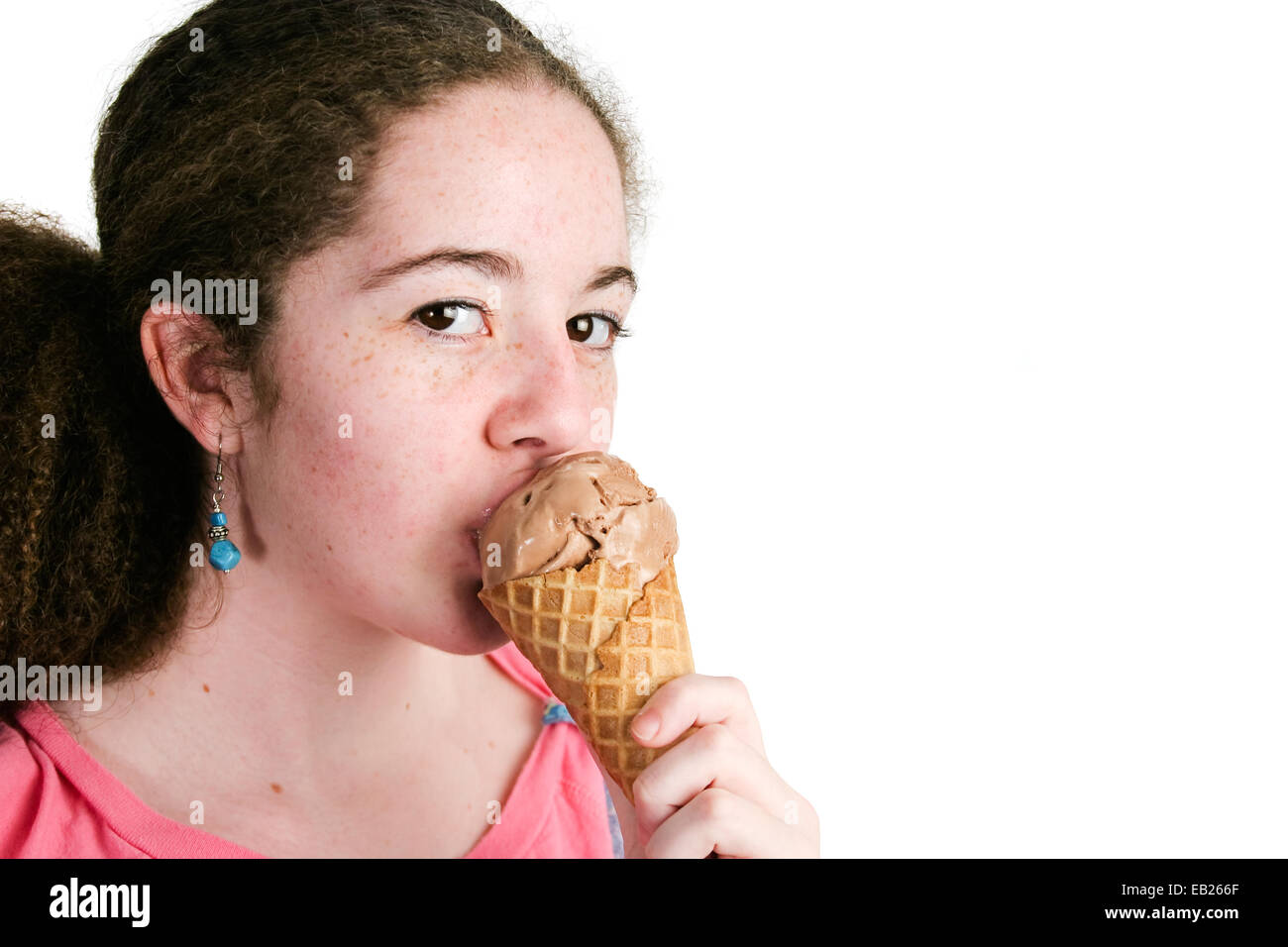 Pretty Young Hispanic Girl Eating A Chocolate Ice Cream Waffle Cone