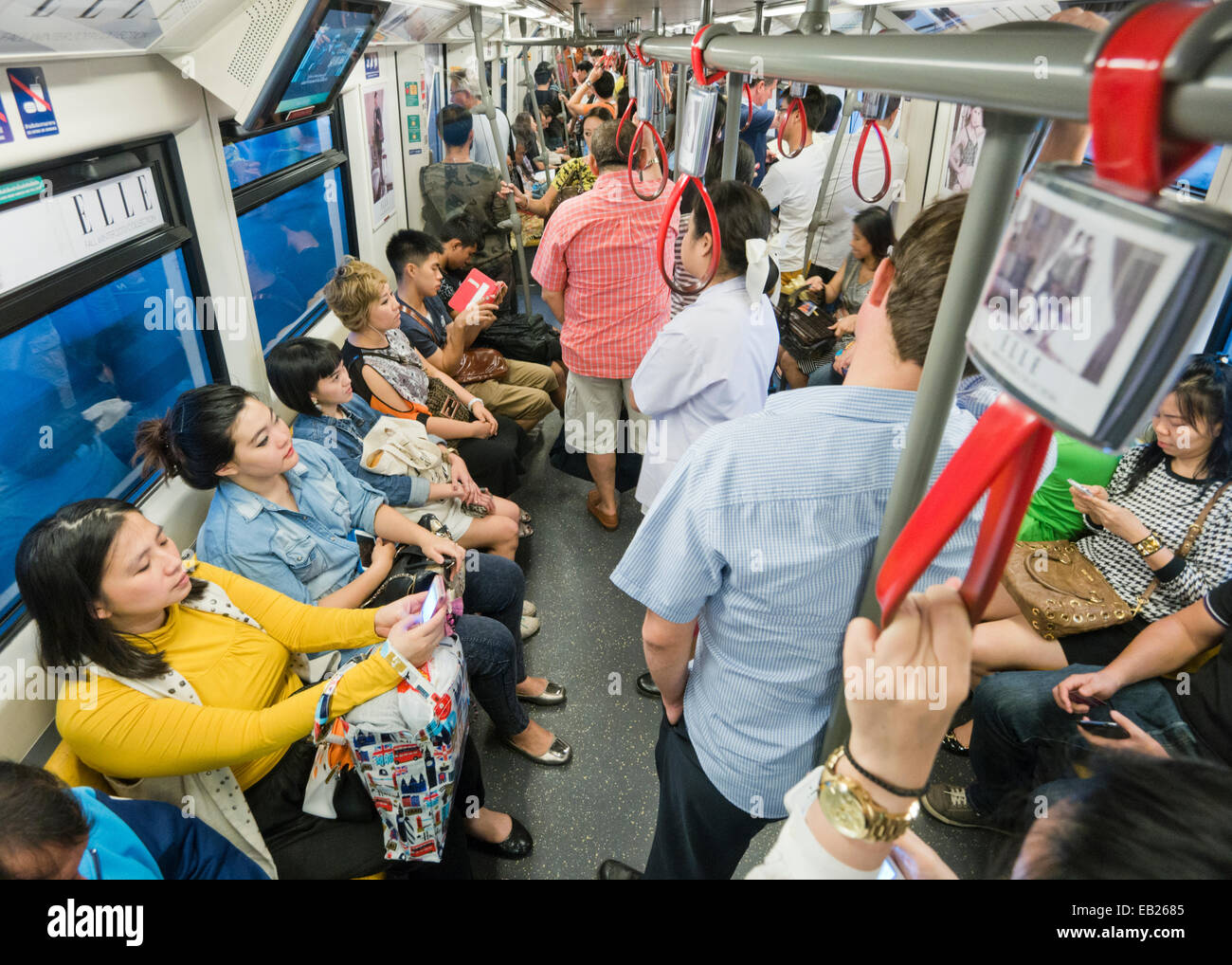 People travelling on a BTS sky train in Bangkok Thailand Stock Photo ...