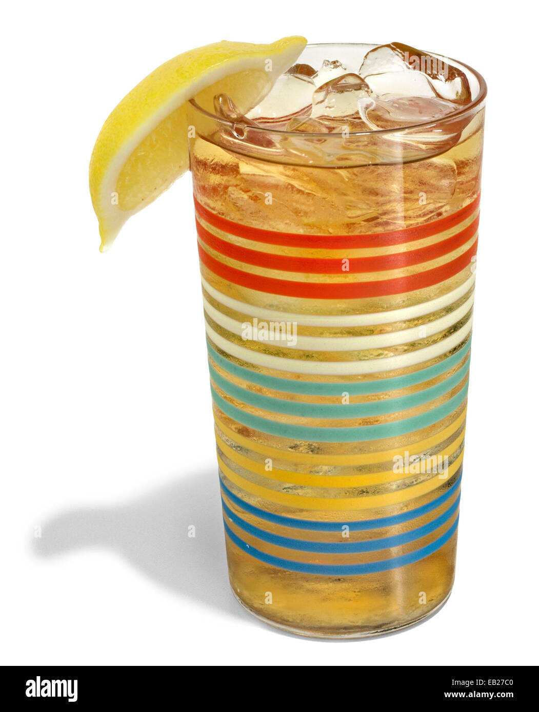 lemon iced tea in a rainbow striped glass photographed on a white ...