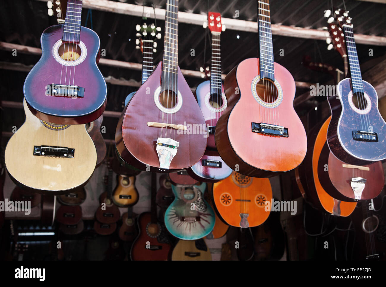 Beautiful hand crafted guitars hanging on display at a market stall in ...