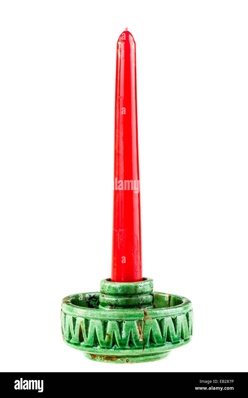 Retro antique candlestick with red candle isolated over a white ...