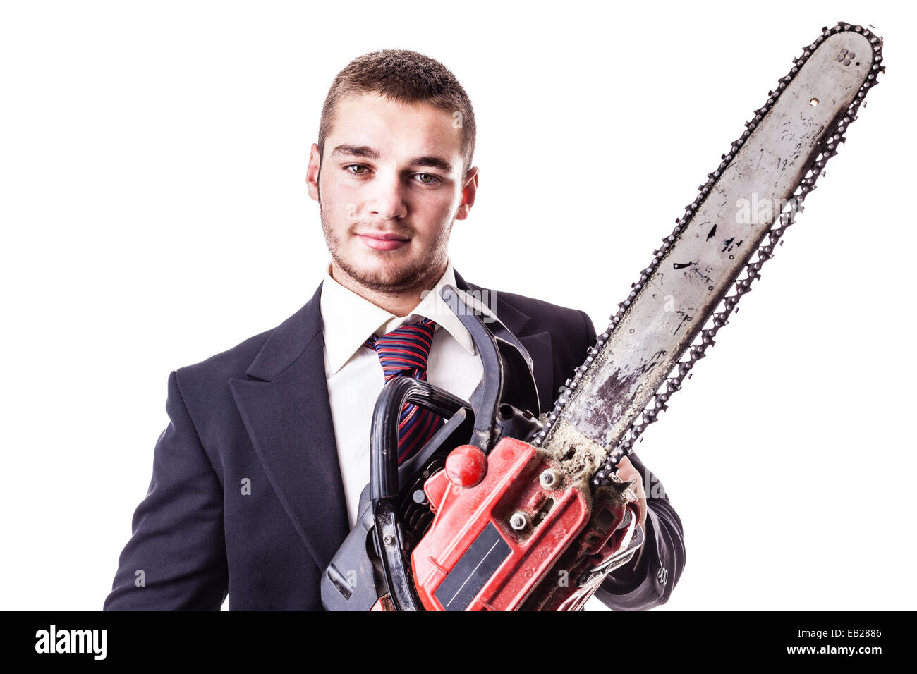 a young businessman holding a red chainsaw isolated over a white ...