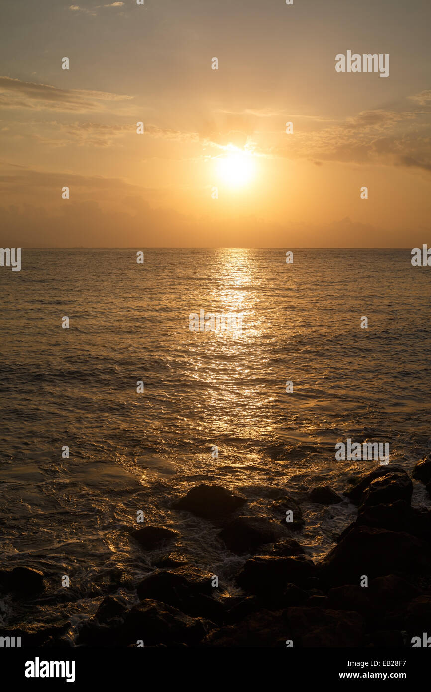 The sun rising over the sea. Vertical shot Stock Photo - Alamy